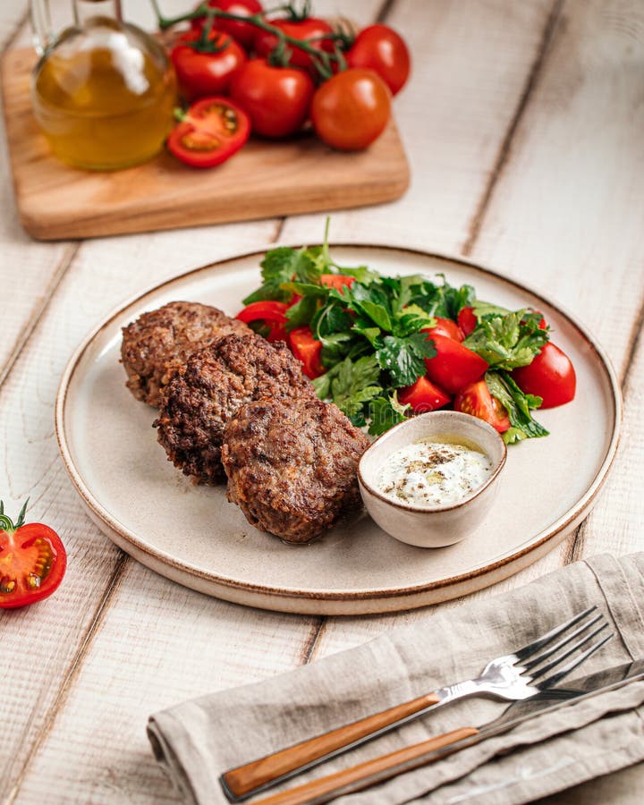 Russian Beef Cutlets with Sauce and Salad Stock Photo - Image of meal ...