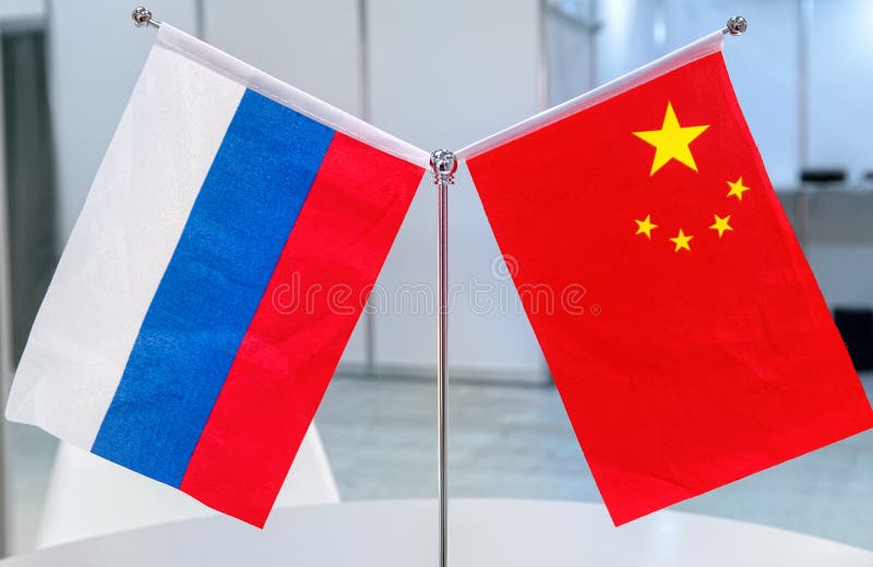 Russian and Chinese Flags on Table in Meeting Room. the Concept of ...