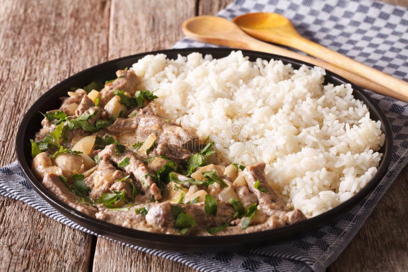 Russian Cuisine: Beef Stroganoff with Rice Close-up on a Plate. Stock ...