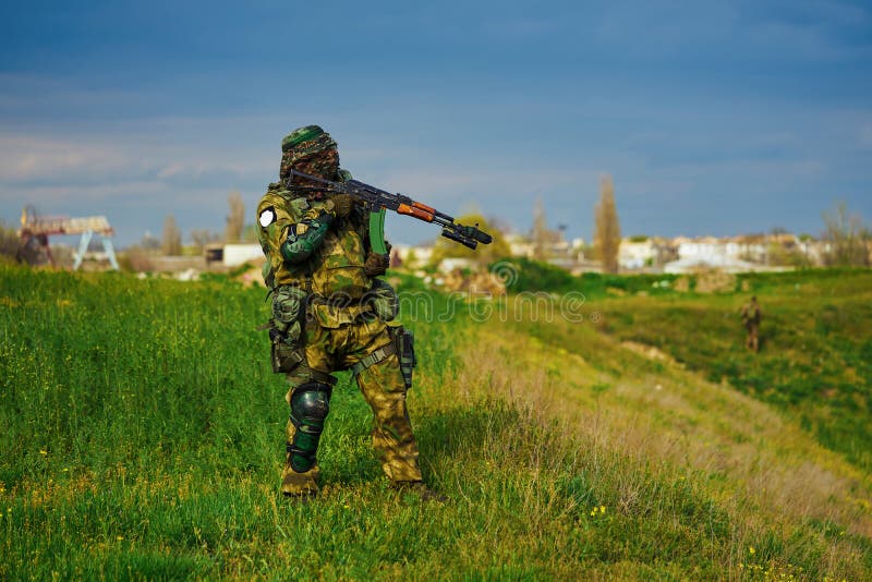 Russian Soldier In Military Uniform Holding A Weapon In His Hands Stock