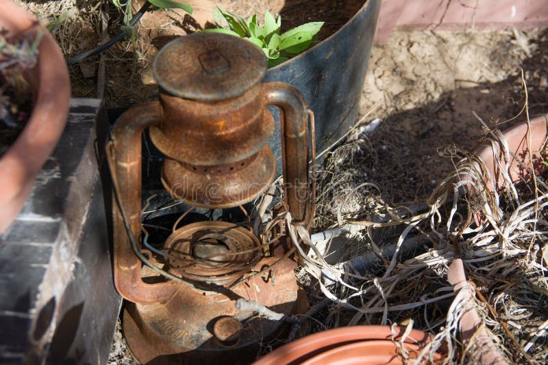 Vuntage Rust and Brocken Kerosene Lamp on Backyard Stock Image - Image ...