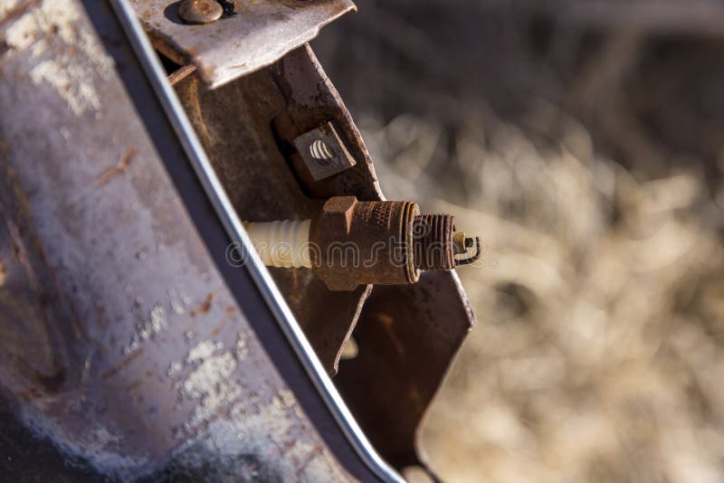 Rust Covered Spark Plug Rests on a Piece of Old Car Engine Stock Photo ...