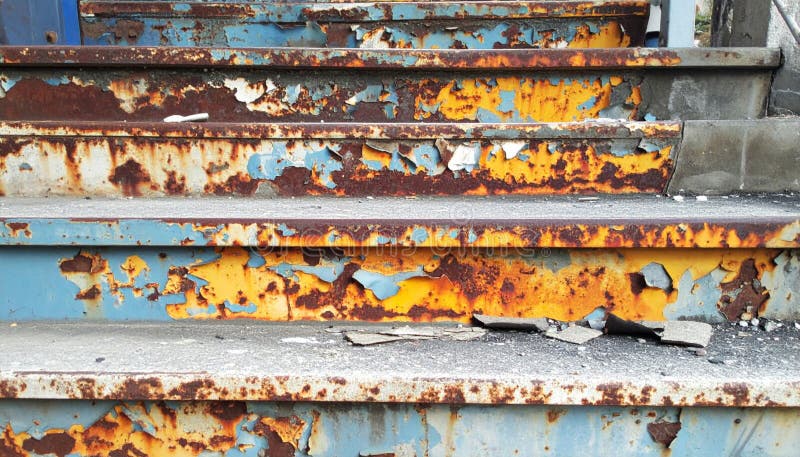 Rust Covered Steps with Peeling Blue and Orange Paint Under Bright ...