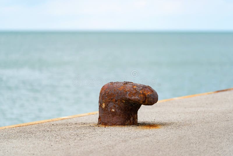 Rusted Bollard on Concrete Pier by the Sea Stock Photo - Image of water ...