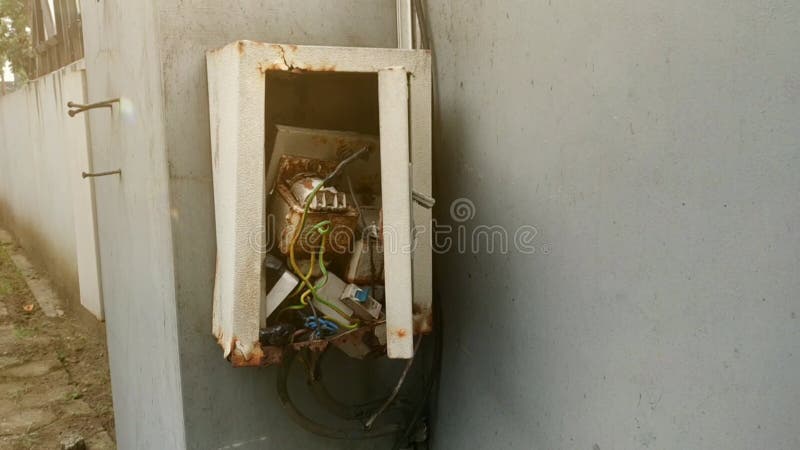 A Rusted, Broken Electrical Panel Mounted on a Concrete Wall. Stock ...