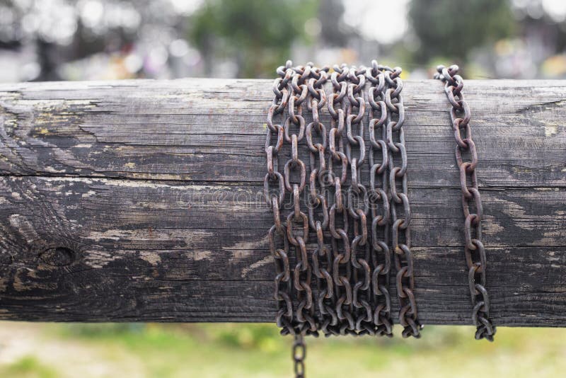 A Rusted Chain Coiled on a Rotating Beam, a Part of an Old Water Well ...