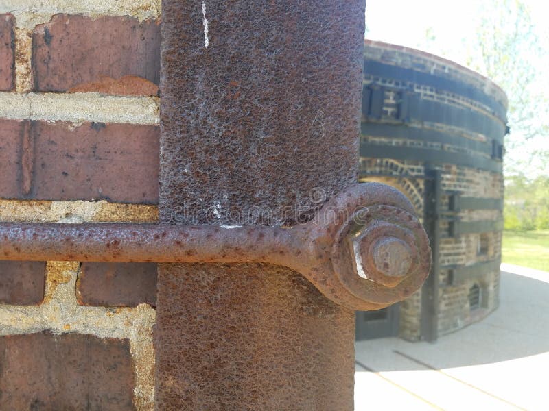Rusted Metal on Brick Building with Old Building in Background Stock ...