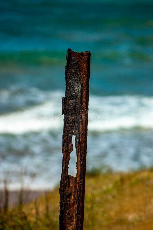 Rusted Metal Fence Post with a Coastal Background Stock Photo - Image ...