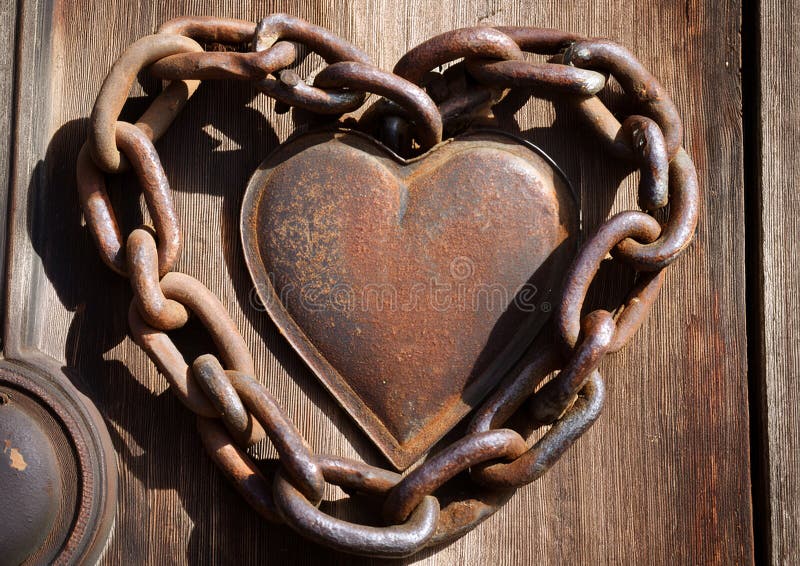 A Rusted Metal Heart is Encircled by a Heavy, Corroded Chain on a ...