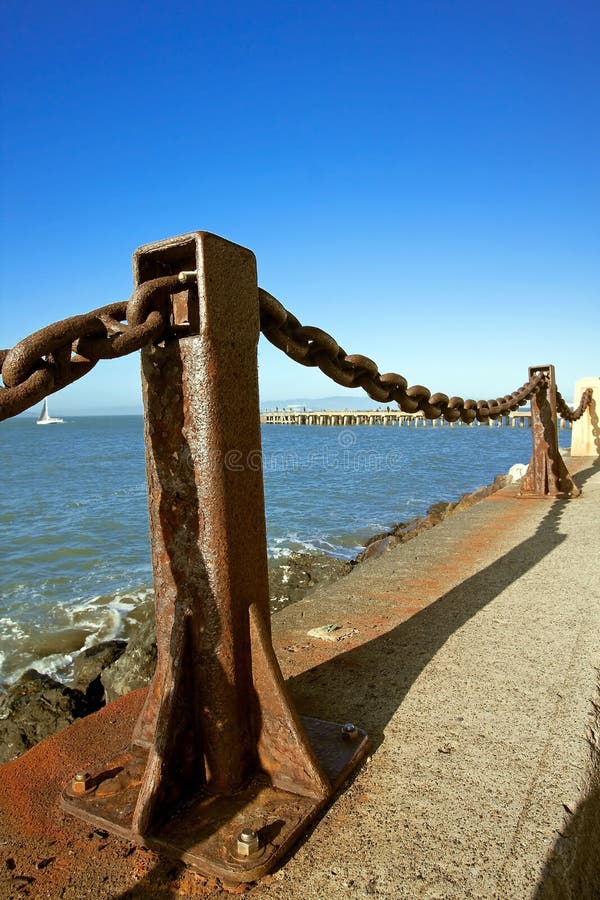 Rusted Metal Post and Chain Fence by Bay Stock Photo - Image of line ...