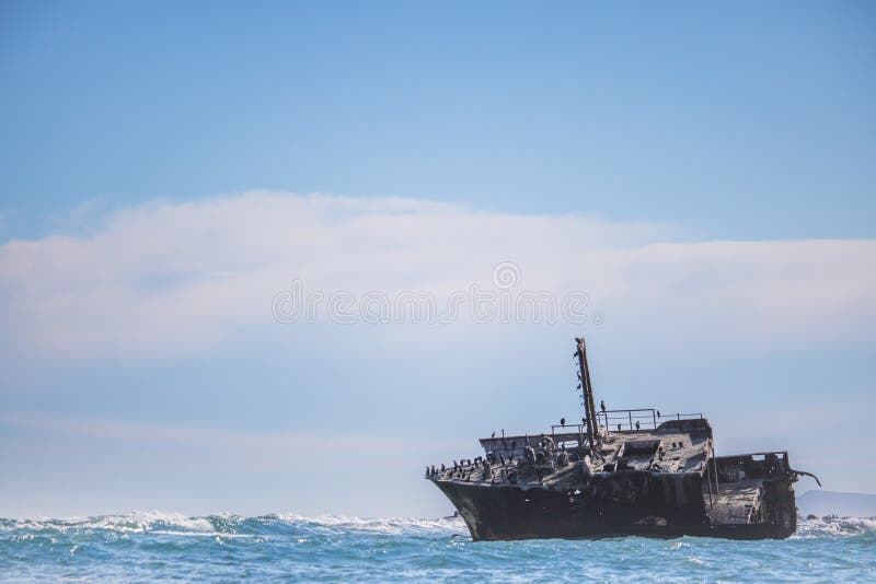 Rusted Old Shipwreck on a Rugged Rocky Coastline. Stock Image - Image ...