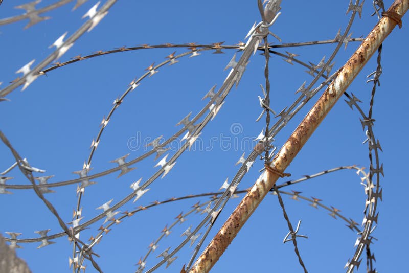 Rusted Razor Security Fence Against Blue Sky Stock Photo - Image of ...