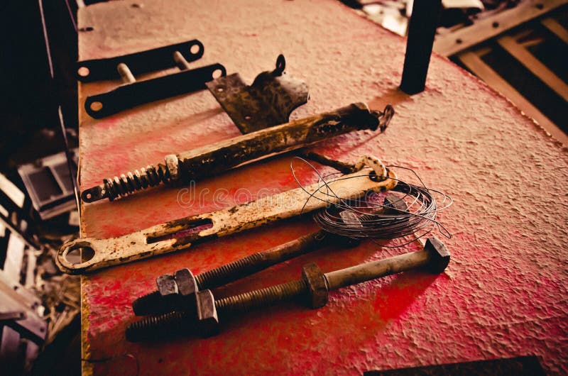 Rusted Tools Lined Up on a Weathered Red Piece of Metal Stock Photo ...