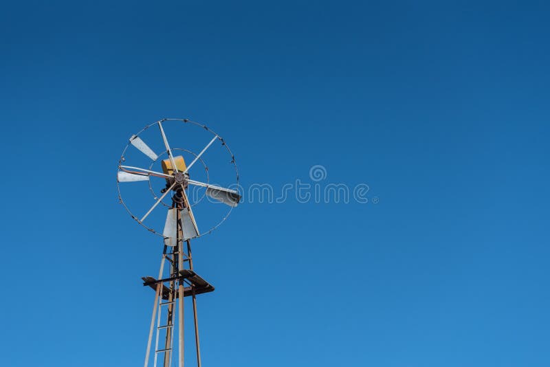 Rusted Windmill in the Desert on Blue Sky Stock Image - Image of round ...