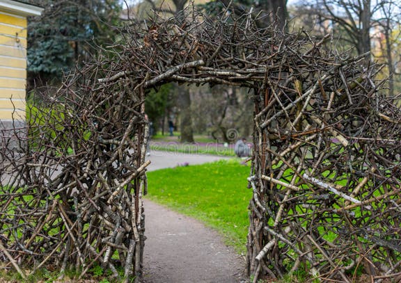 A Rustic Arch Built from Branches in a Park Stock Image - Image of ...