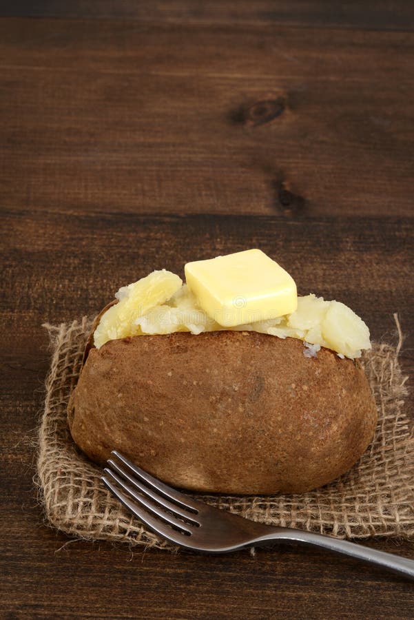 Rustic Baked Potato with Butter Stock Image - Image of silverware ...