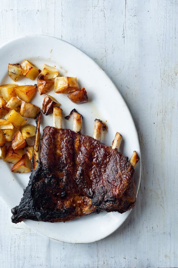 Rustic barbequed pork ribs stock image. Image of grilled - 229091911