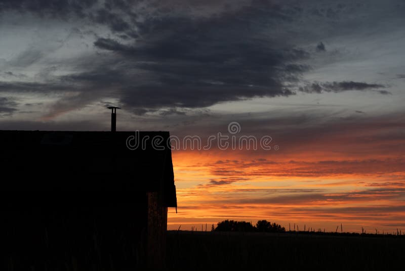Rustic Barn Silhouette Under a Sunset Sky Prairie Landscape in Rocky ...