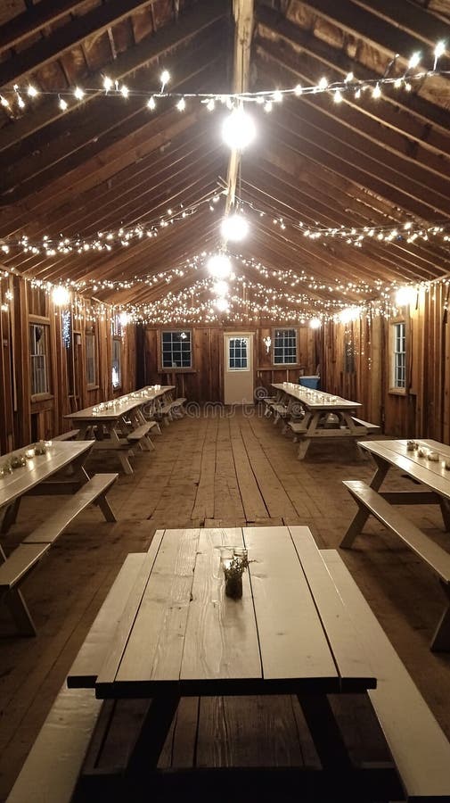 A Rustic Barn Venue Set Up for a Wedding with String Lights and Stock ...