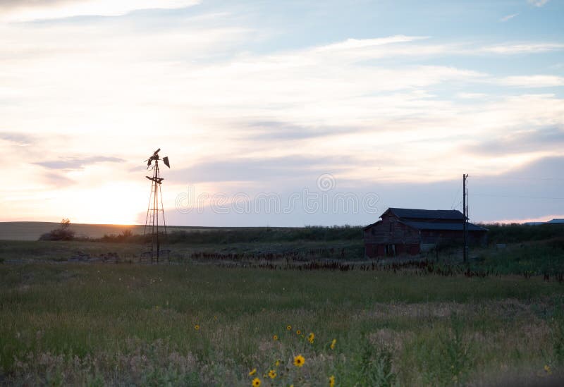 A Rustic Barn and Wildmill at Sunset Stock Image - Image of horizontal ...