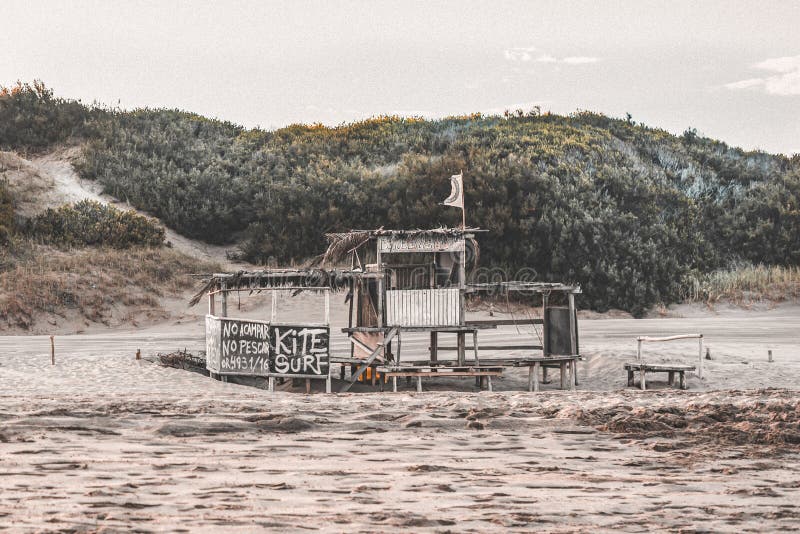 Rustic Beach Hut with a Sign for Kite Surfing Near the Sandy Dunes ...