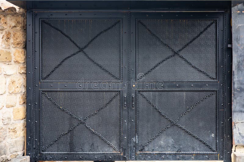 Rustic Black Metal Gate with Stone Wall Backdrop Stock Image - Image of ...