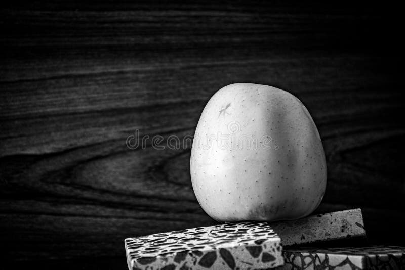 Rustic Black and White Image of an Apple on a Stack of Tiles on with a ...