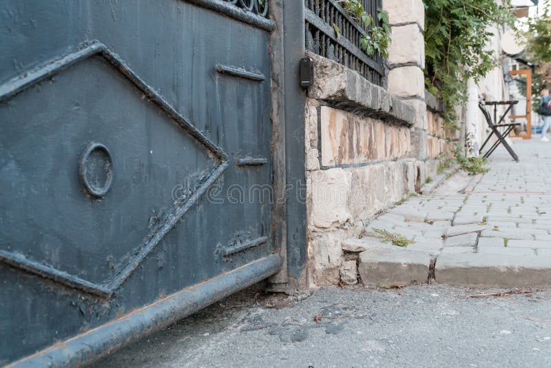 Rustic Blue Gate with Stone Pathway and Charming Street View Stock ...