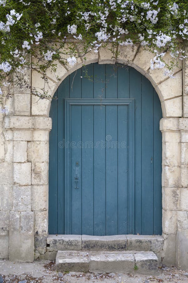Rustic Blue Wooden Door with White Flowers Above Stock Photo - Image of ...