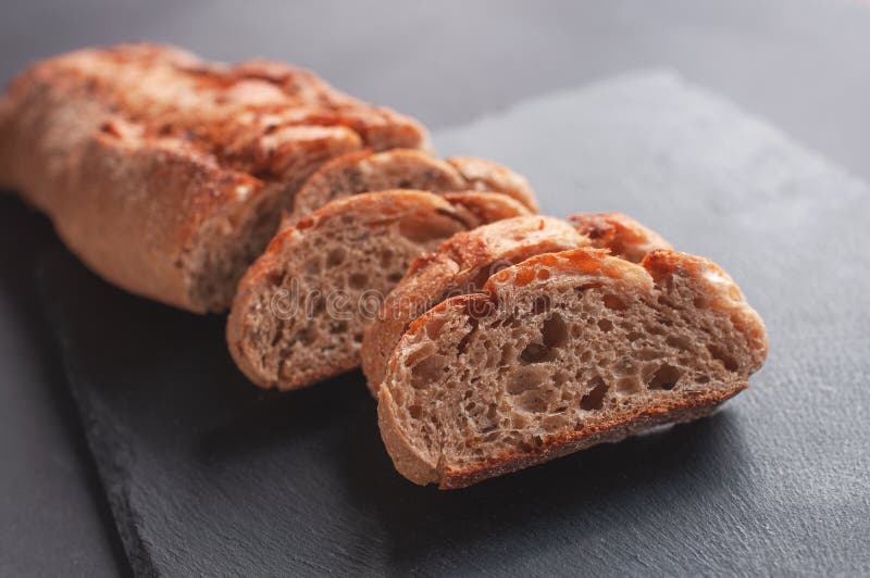 Rustic Bread, Beautiful Golden Crust, Sliced Bread Lying on Black Board ...