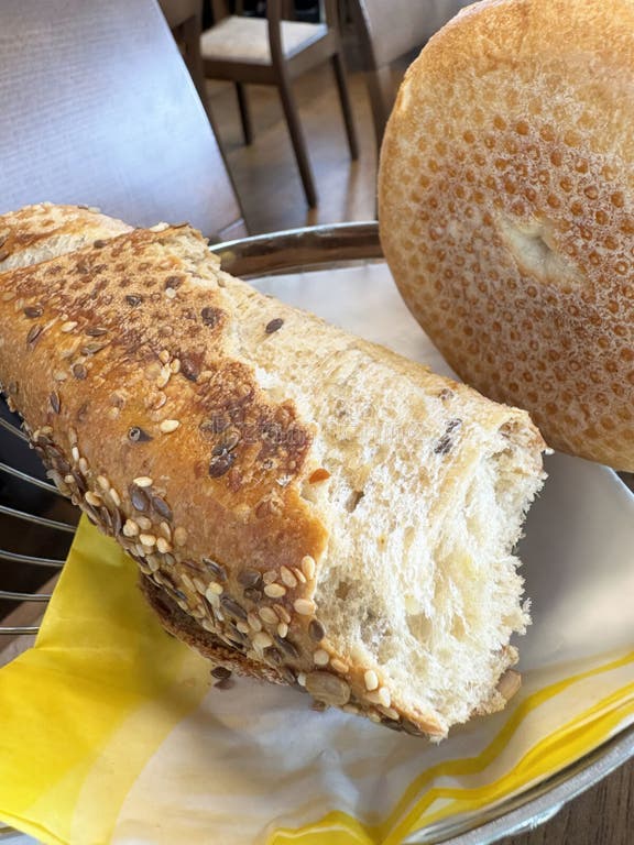 Rustic Bread Duo on Table: Seeded Baguette and Round Loaf in Dining ...