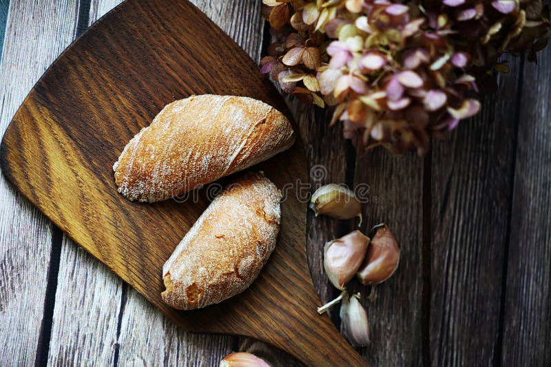 Rustic Bread Rolls with Garlic and Dried Flowers Stock Photo - Image of ...