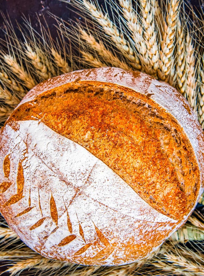 Rustic Bread with Seeds on a Wooden Table in Flour, Black Background ...