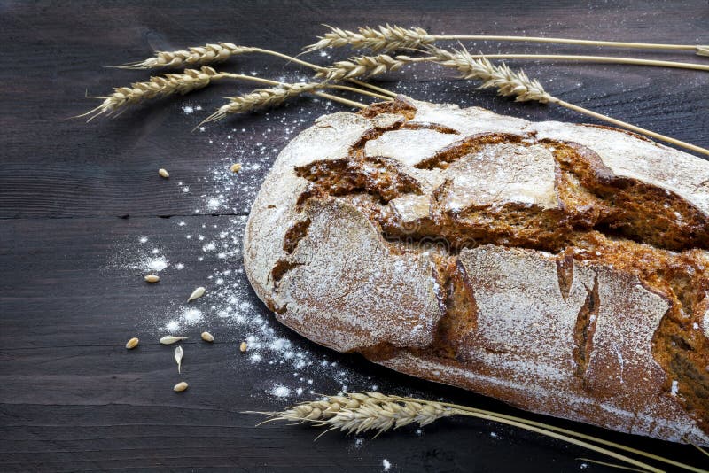 Rustic Bread and Wheat on a Dark Wooden Table Stock Photo - Image of ...