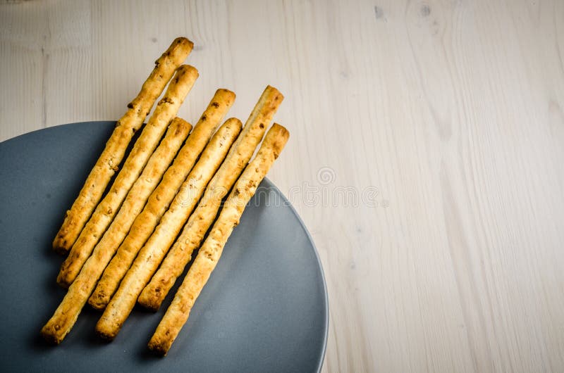 Rustic Breadsticks in a Dish on Wood Table, Close Up, Background Stock ...