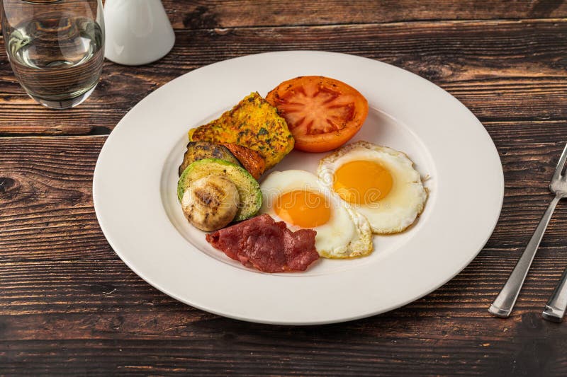 Rustic Breakfast Plate with Fried Eggs, Grilled Vegetables, and Turkey ...