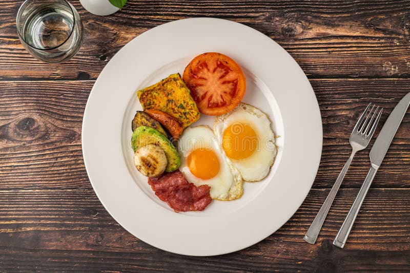 Rustic Breakfast Plate with Fried Eggs, Grilled Vegetables, and Turkey ...