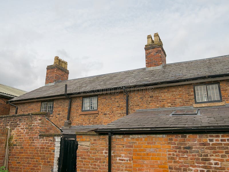 Rustic Brick House Terraced with Chimney Stacks Under a Cloudy Sky ...