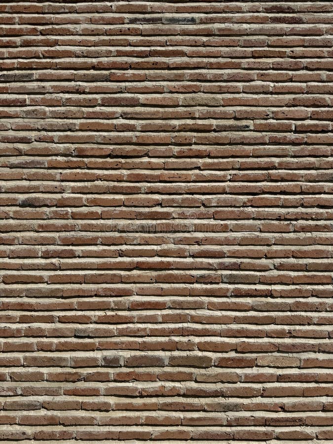 A Rustic Brick Wall Made of Long, Narrow, Uneven Red Bricks Laid in ...