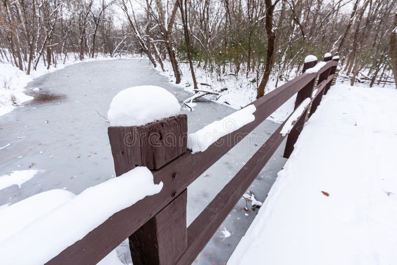 A Rustic Bridge Crosses Over a Stream or River Surrounded by Lush ...