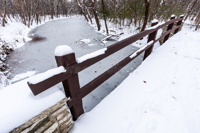 Rustic Bridge Over Frozen River in Winter Stock Photo - Image of snow ...