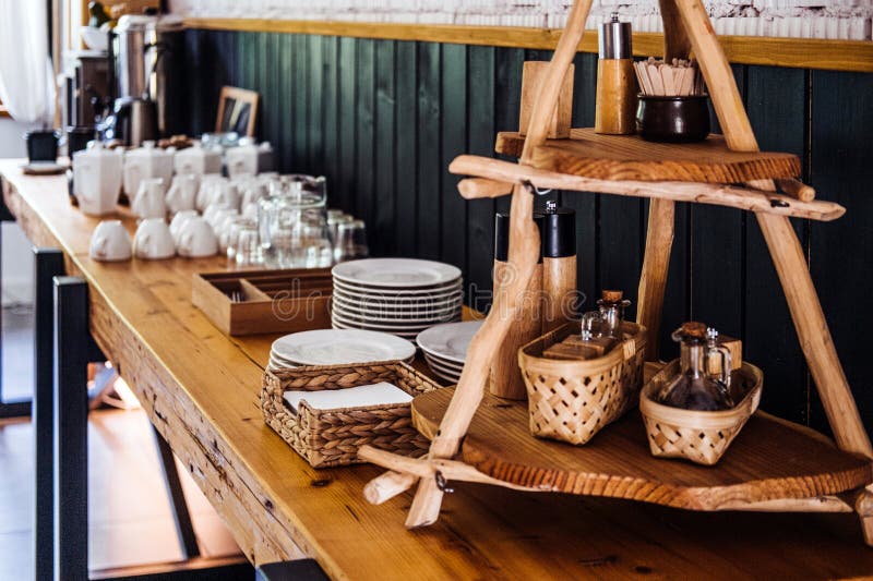 Rustic Buffet Table Setup with Plates, Cups, Glasses, and Wooden ...
