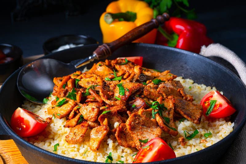 Rustic Bulgur Pans with Gratinated Gyros and Yoghurt Stock Photo ...