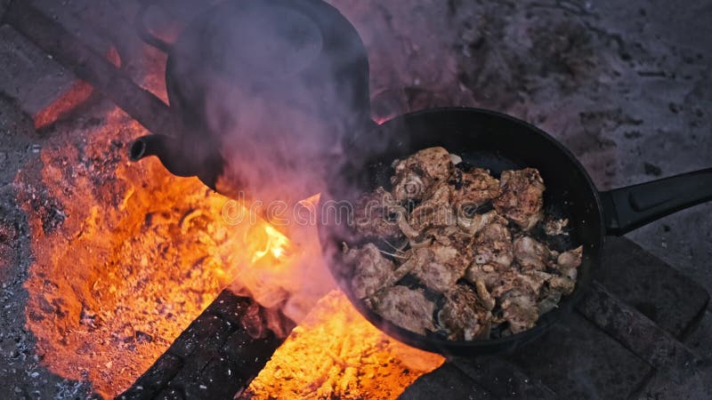 Rustic Campfire Cooking: Chicken and Kettle Over Flames Stock Footage ...