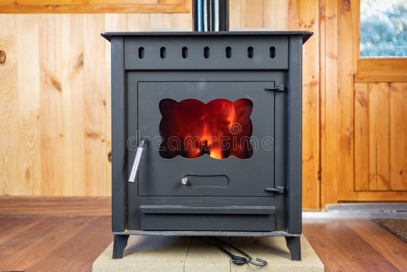 Rustic Cast Iron Stove with the Fire Lit Inside To Heat the House ...