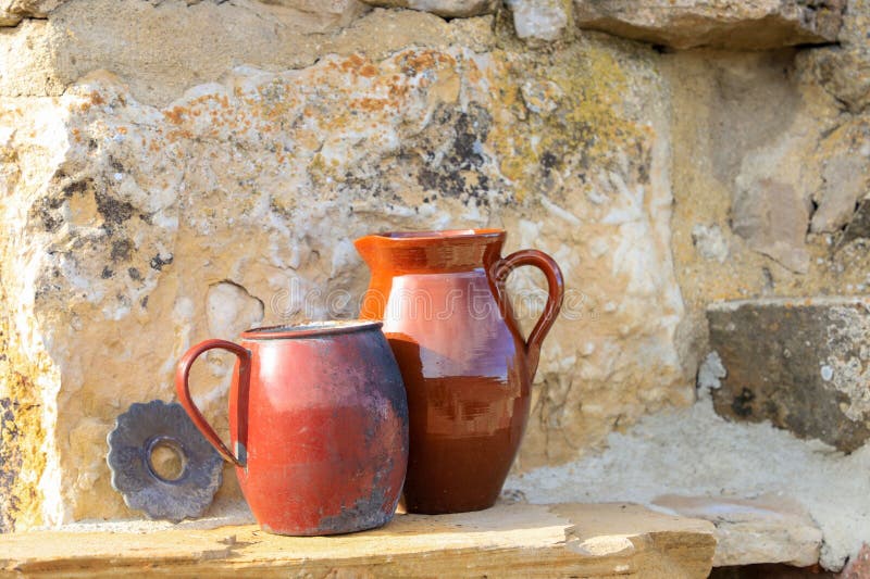 Rustic Ceramic Jugs on a Stone Ledge. Stock Image - Image of clay, jugs ...