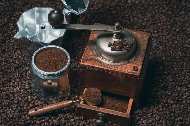 Rustic Coffee Grinder with a Measuring Spoon and an Espresso Maker with ...