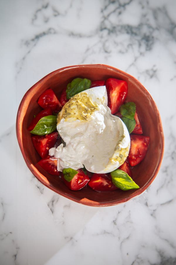 Buratta with Tomatoes and Basil in a Clay Bowl. Stock Image - Image of ...