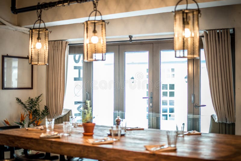 Rustic Country Style Restaurant with White Walls, Table Seating and ...