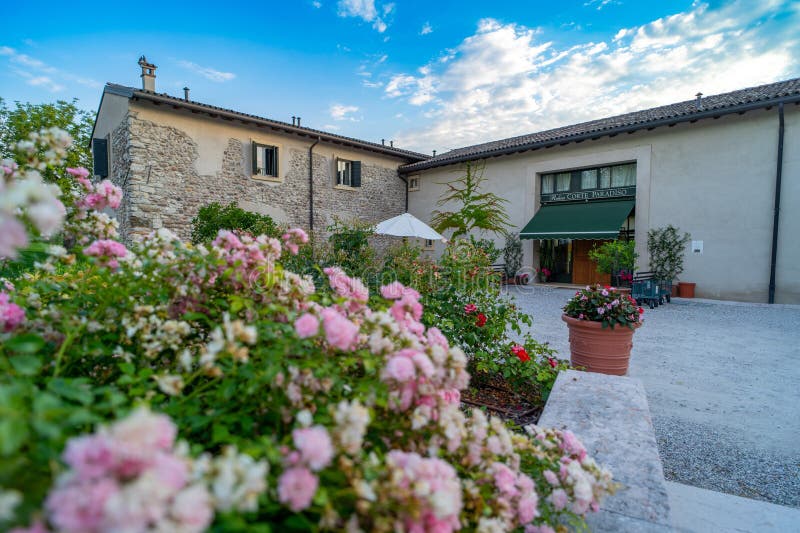 Rustic Courtyard with Flowers and Stone Building in Scenic Setting ...